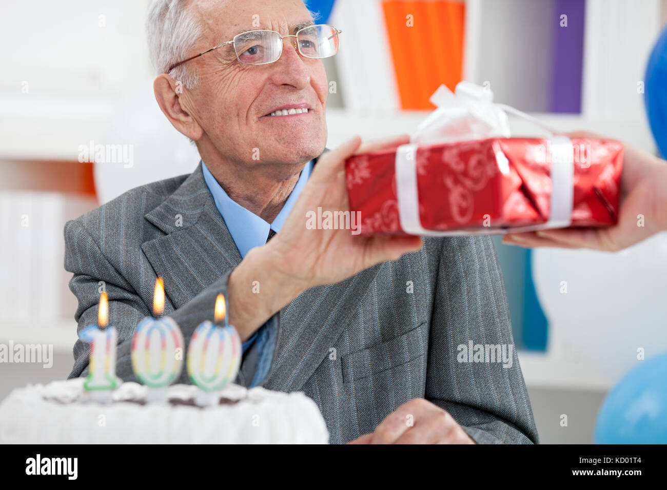 senior man receiving gift for birthday Stock Photo - Alamy