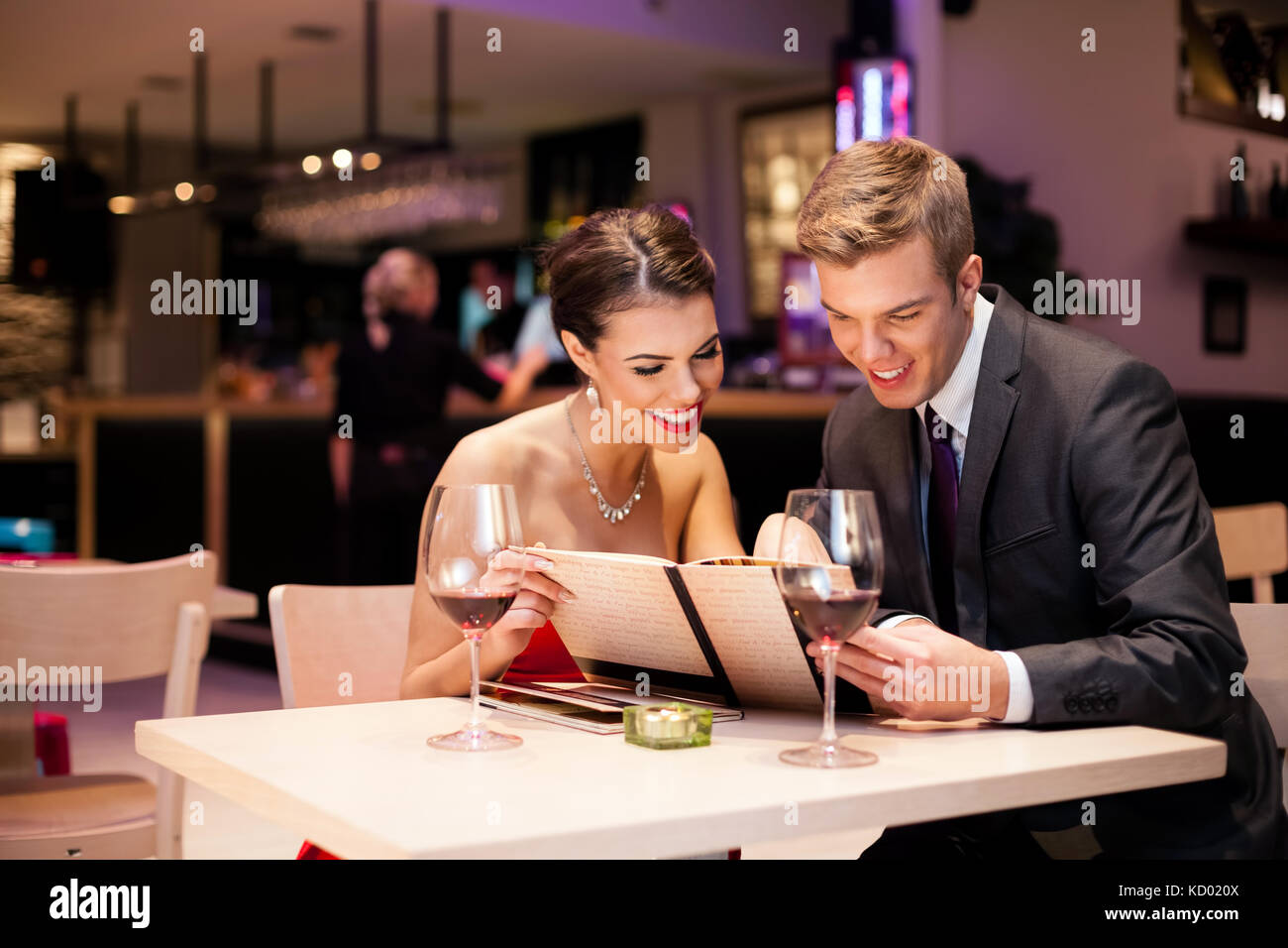 Couple reading at menu together in a restaurant Stock Photo - Alamy