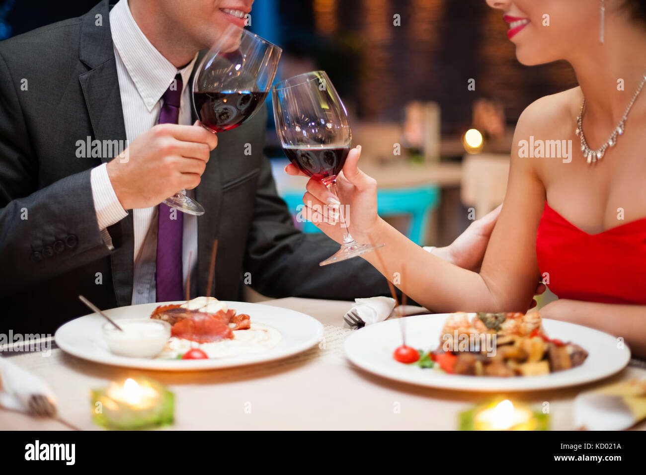Hand holding a glass with red wine and toasting, celebration Stock ...