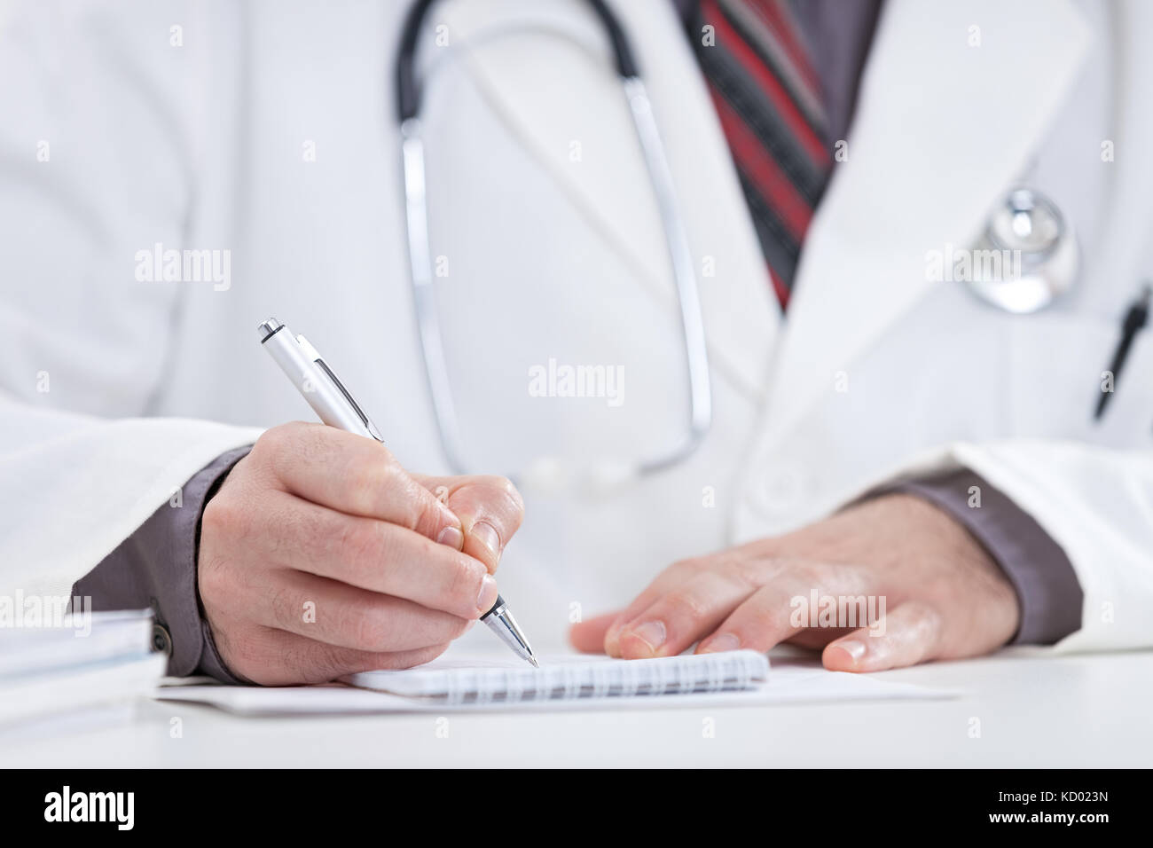 Doctor writing prescription Stock Photo - Alamy