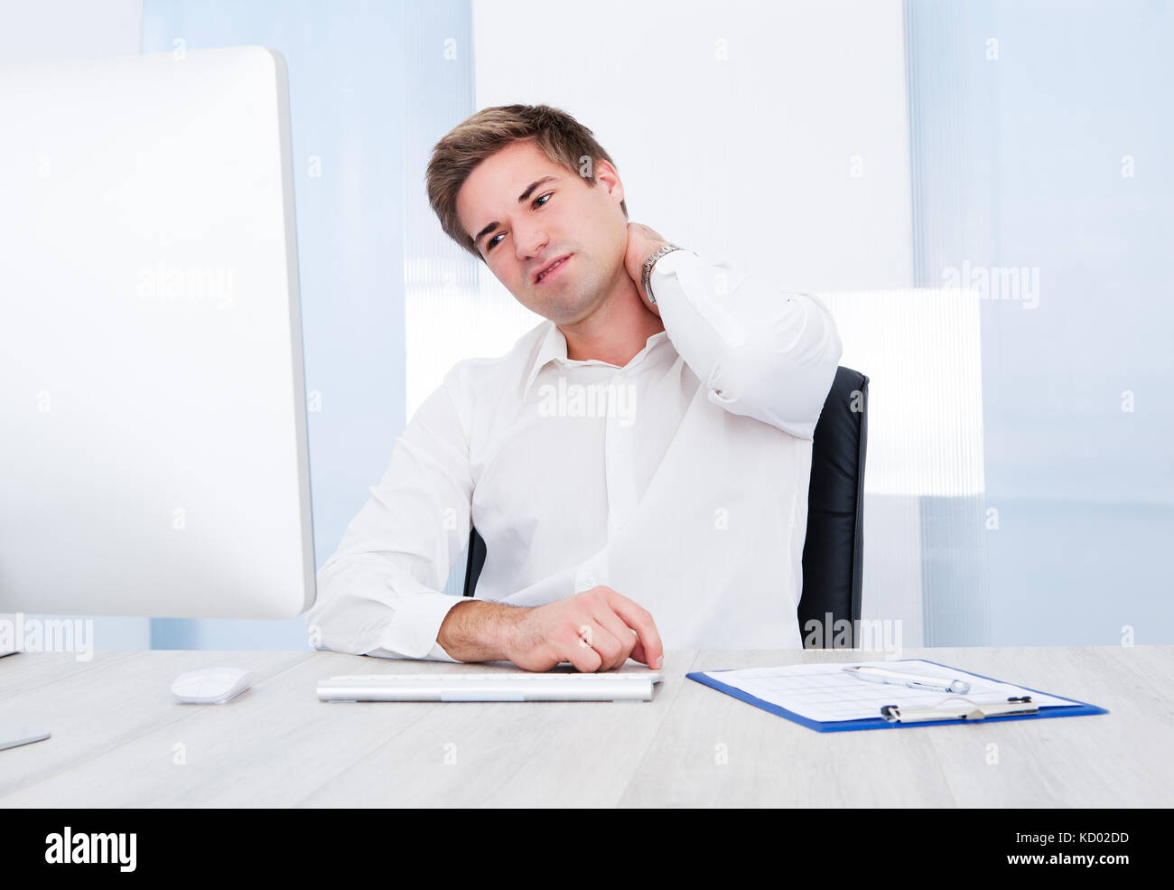 Young Businessman Using Computer Suffering From Neck Ache Stock Photo ...