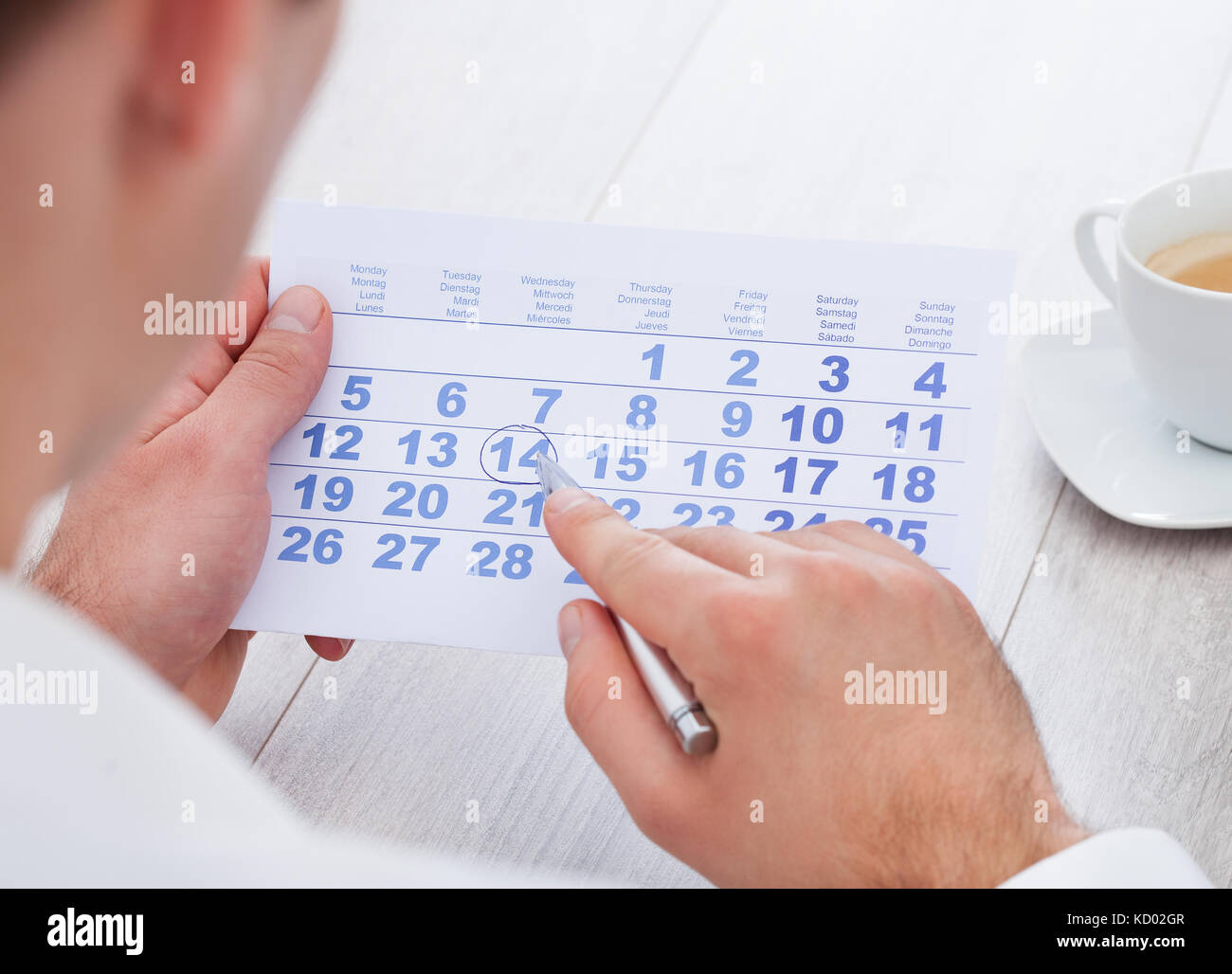 Close-up Of Man Marking With Pen And Looking At Date On Calendar Stock ...