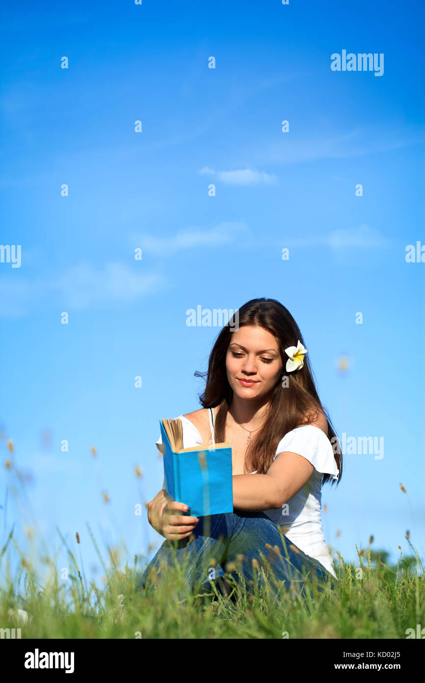 Young beautiful woman reading book in nature Stock Photo - Alamy