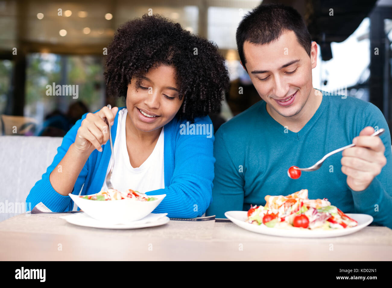 young couple eating lunch at restaurant Stock Photo - Alamy
