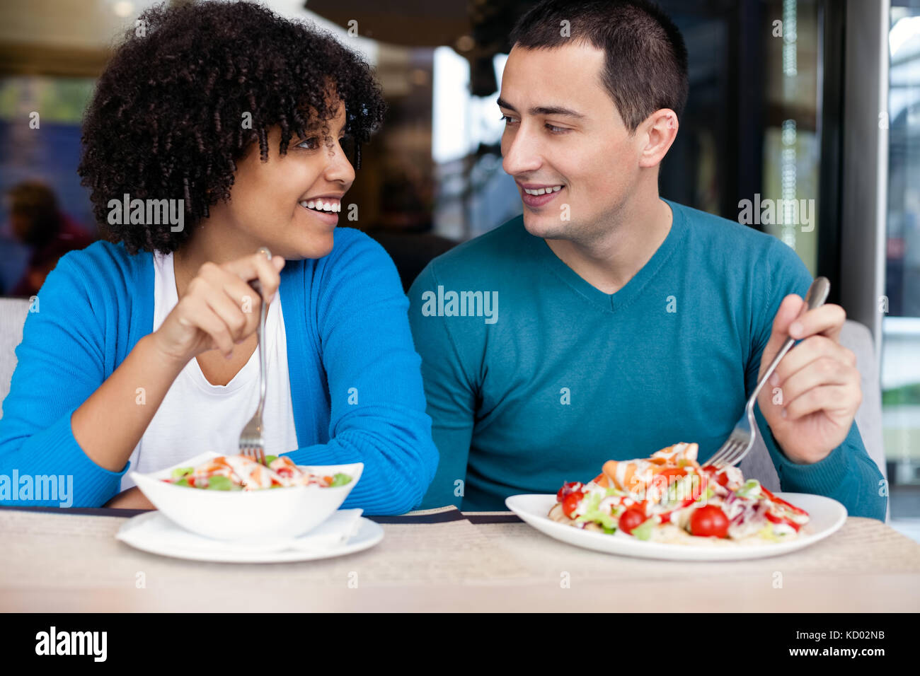 Happy young couple having lunch in restaurant Stock Photo - Alamy