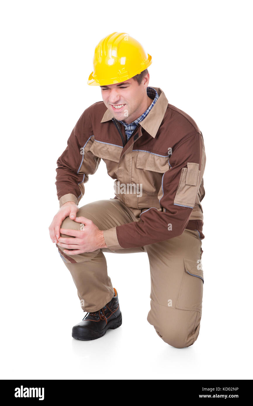 Mechanic Suffering From Knee Injury On White Background Stock Photo - Alamy