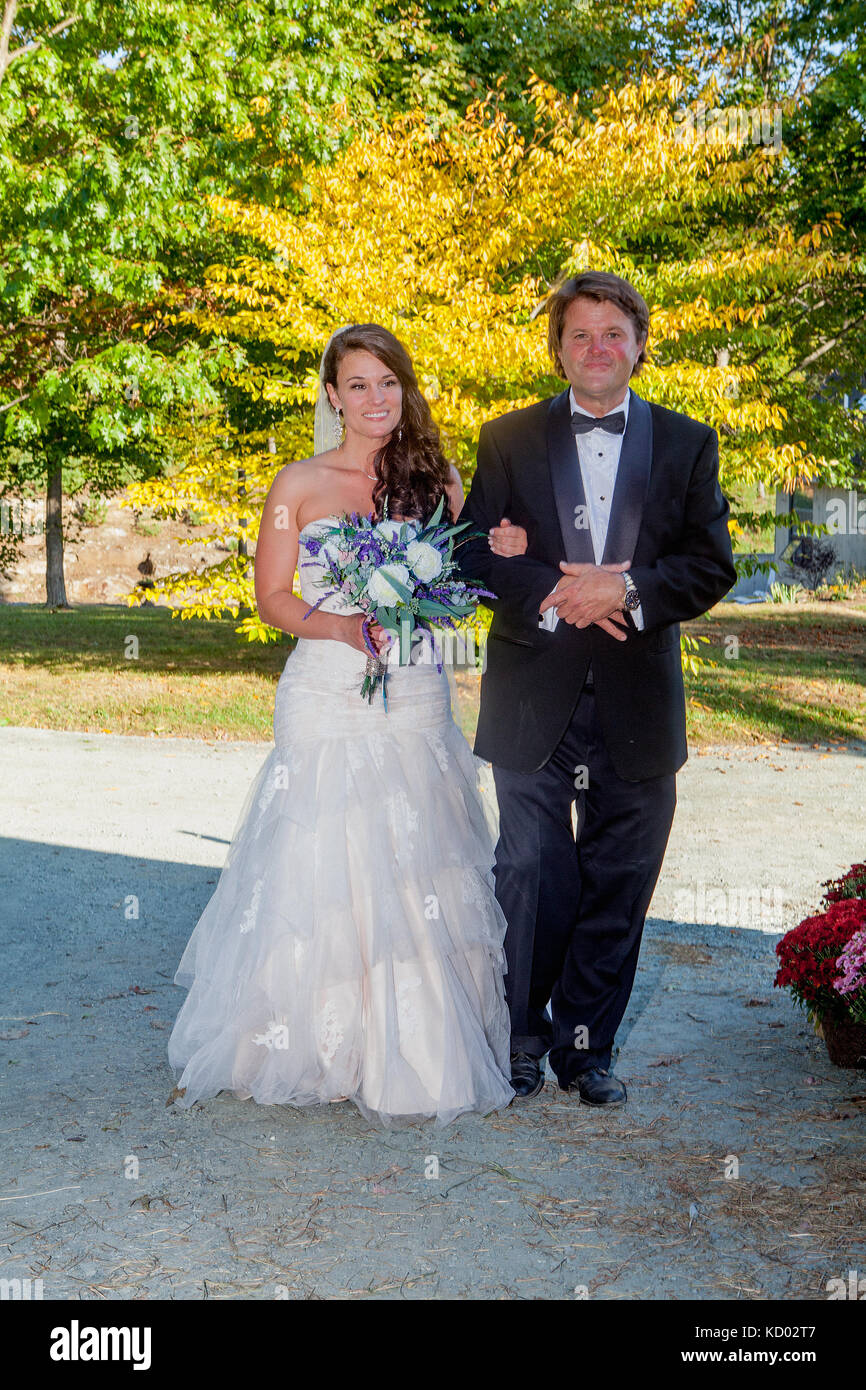 A bride and her father in a wedding ceremony. Father is giving away the ...