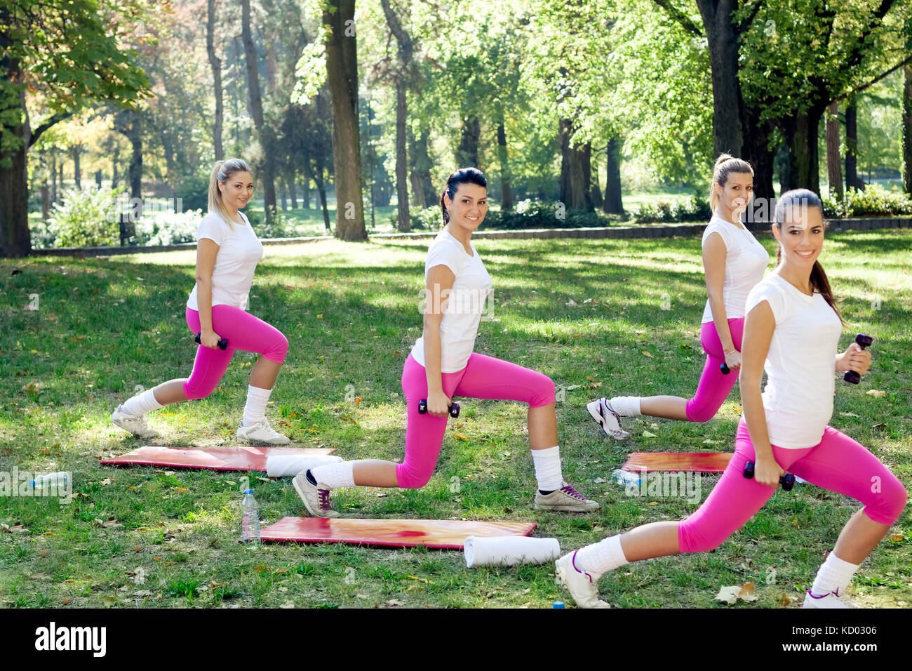 Group of smiling women doing exercise with dumbbell Stock Photo - Alamy