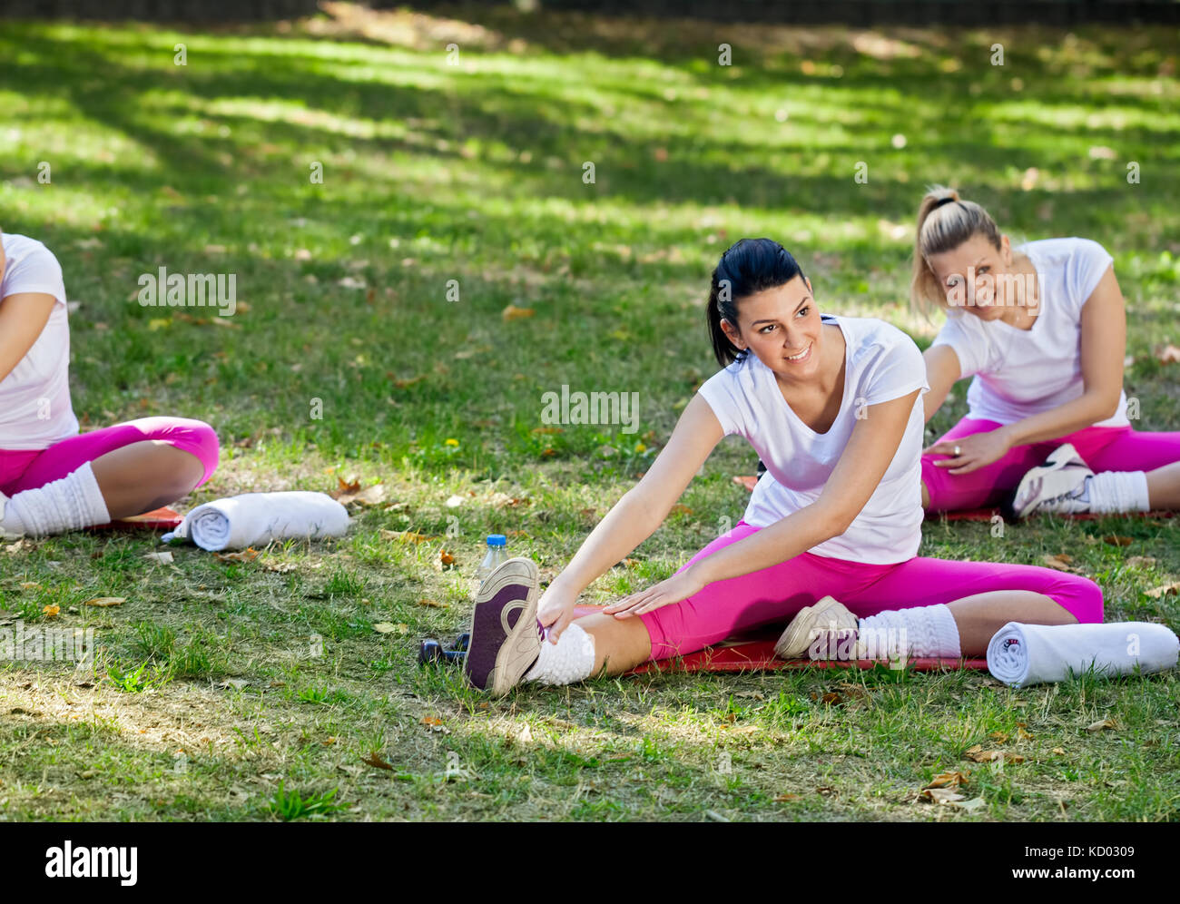 Group of women in a pilates class stretching Stock Photo - Alamy