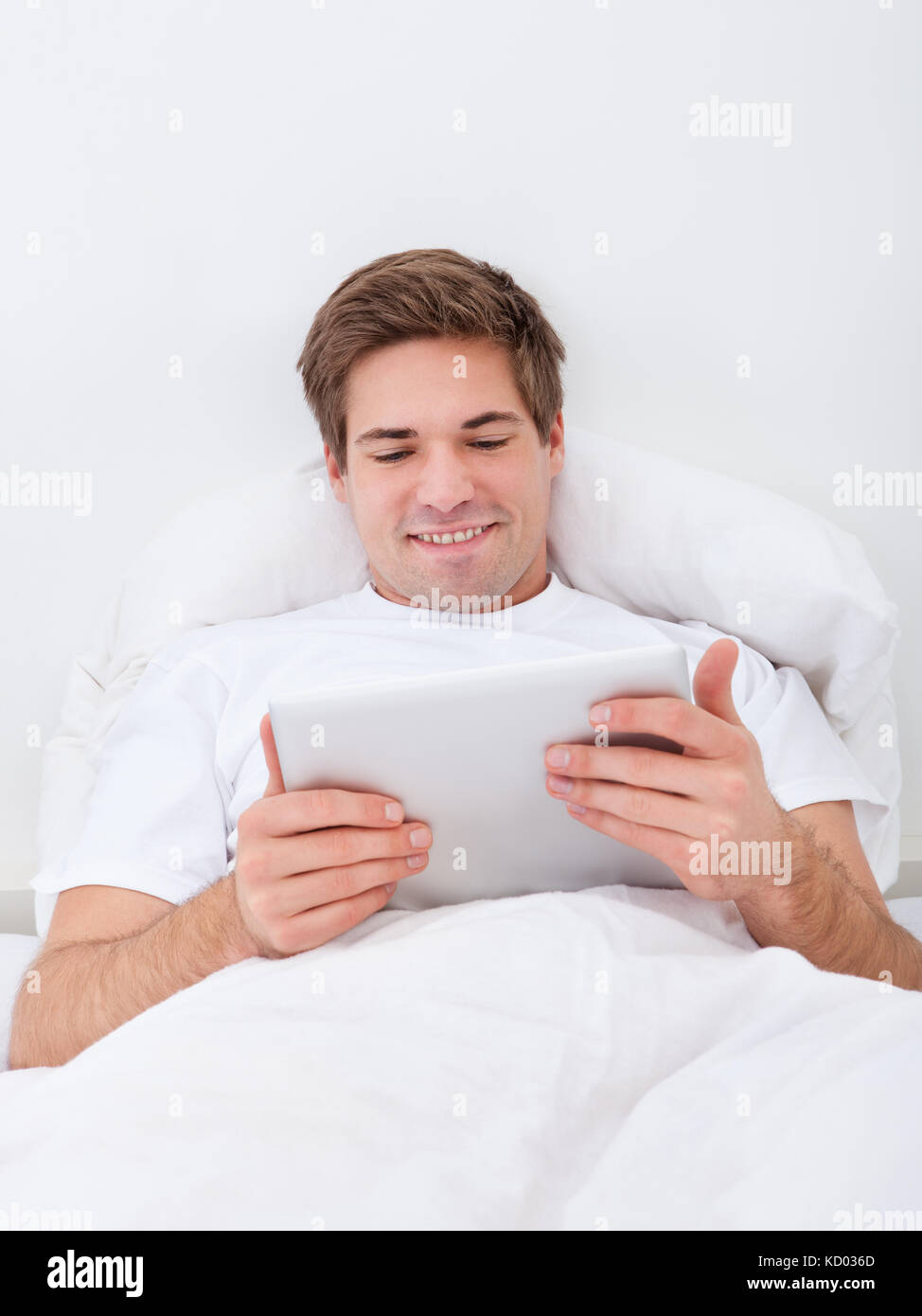 Young happy man smartphone tablet hi-res stock photography and images ...