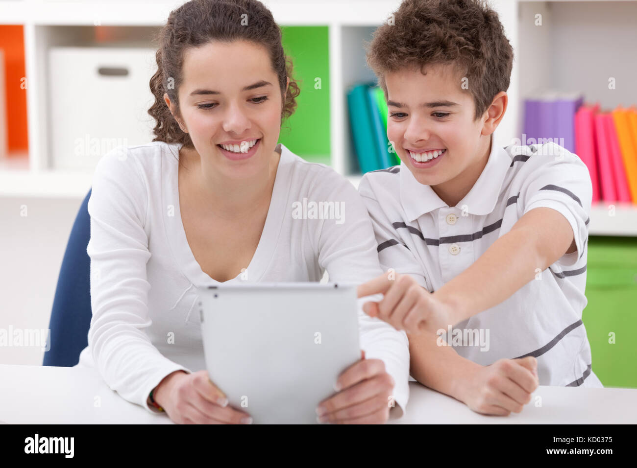 Two happy children have fun tablet pc Stock Photo - Alamy