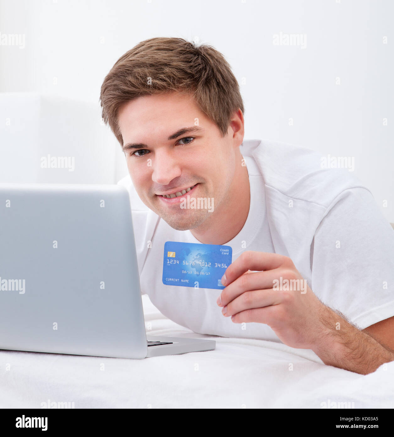 Happy man home laptop card shopping hi-res stock photography and images ...
