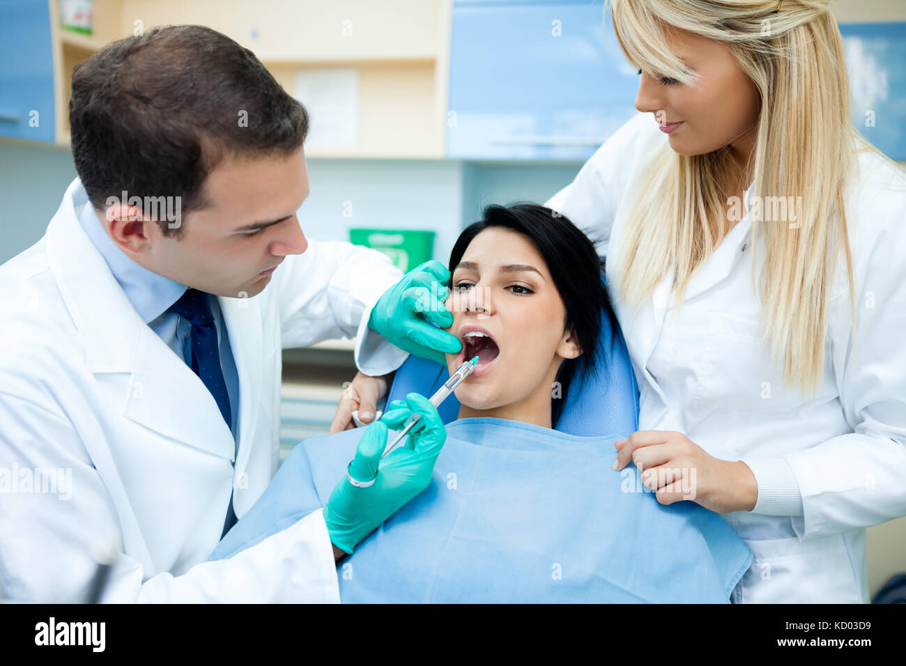 The dentist makes an injection at the clinic Stock Photo - Alamy