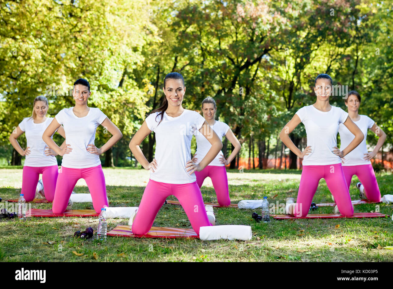 Group of young women doing exercise in starting position Stock Photo ...