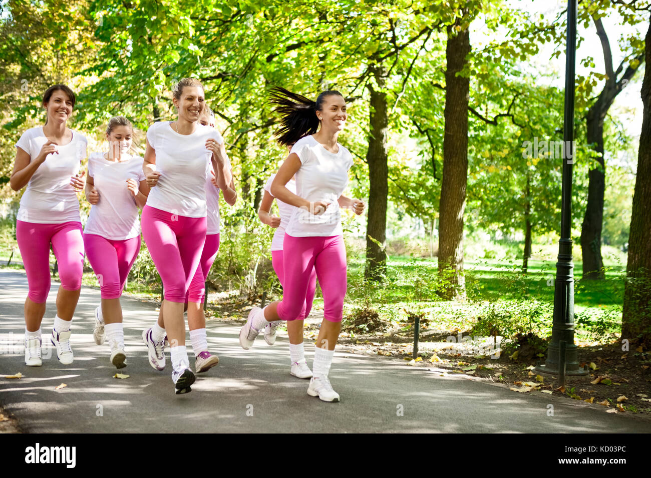 Runners. Jogging group in park Stock Photo - Alamy