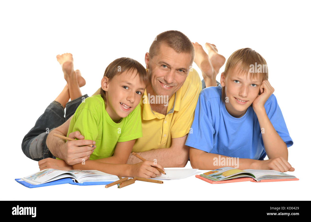 Father and sons doing homework together Stock Photo - Alamy