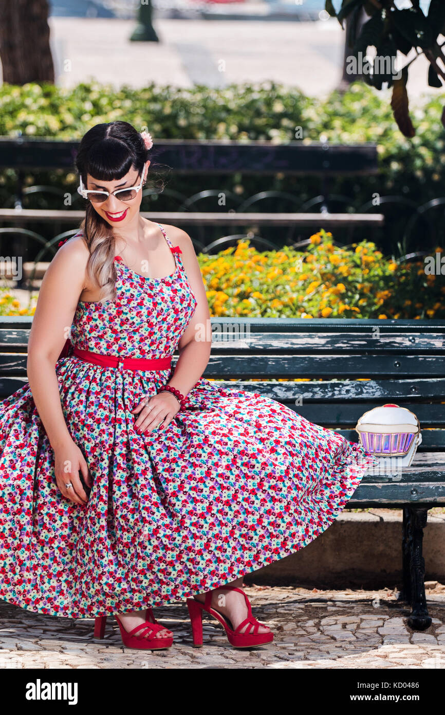 Pinup girl with dress relaxing in the beautiful urban park Stock Photo ...