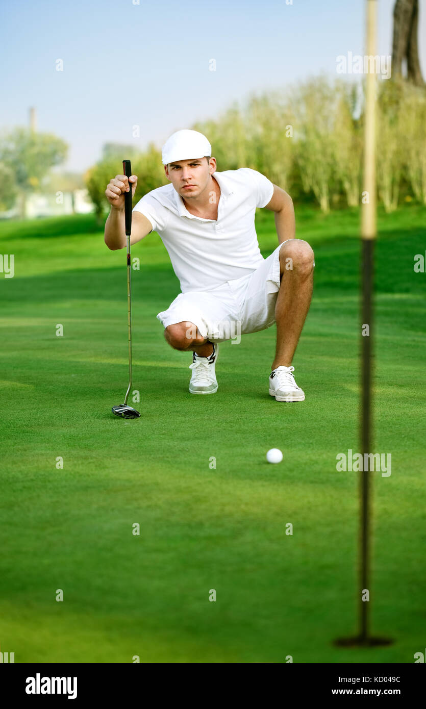 Young golfer lines up his eagle putt Stock Photo - Alamy
