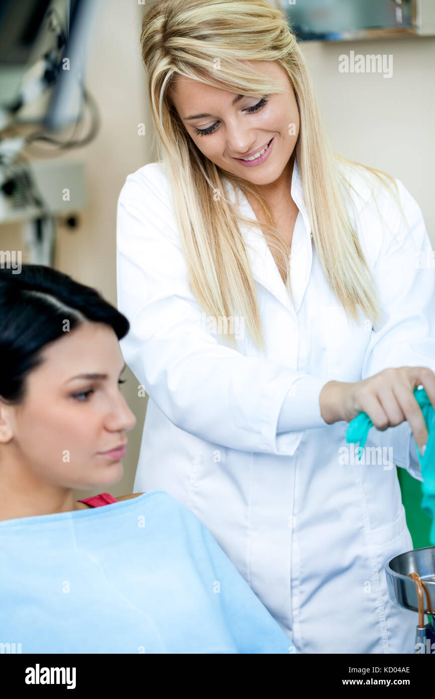 Young smiling dentist assistant with patient Stock Photo - Alamy