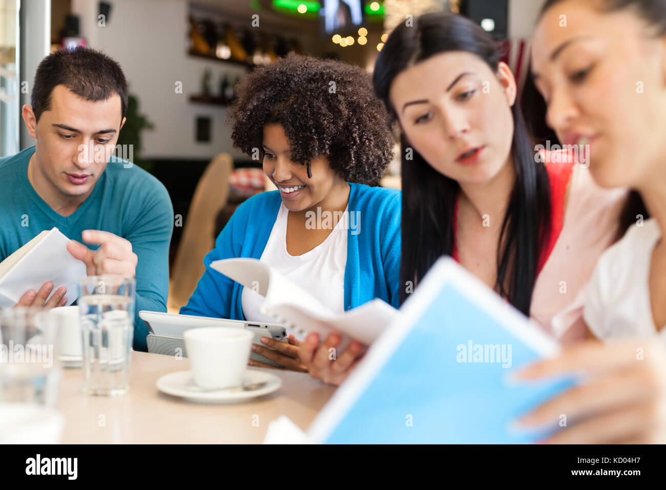 Group of student learning together in coffee shop Stock Photo - Alamy