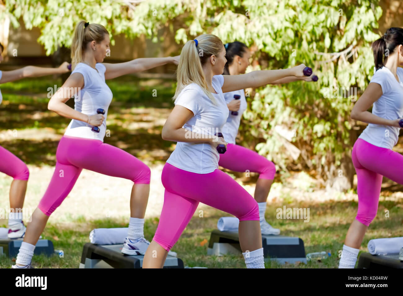 Young women doing exercise with dumbbells Stock Photo - Alamy