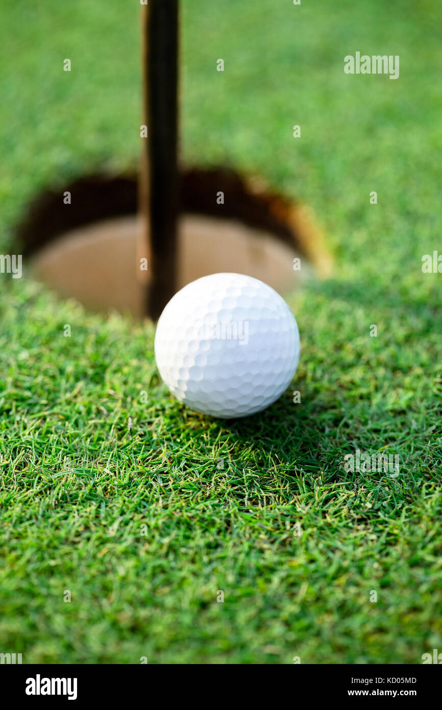 Golf ball next hole Stock Photo - Alamy