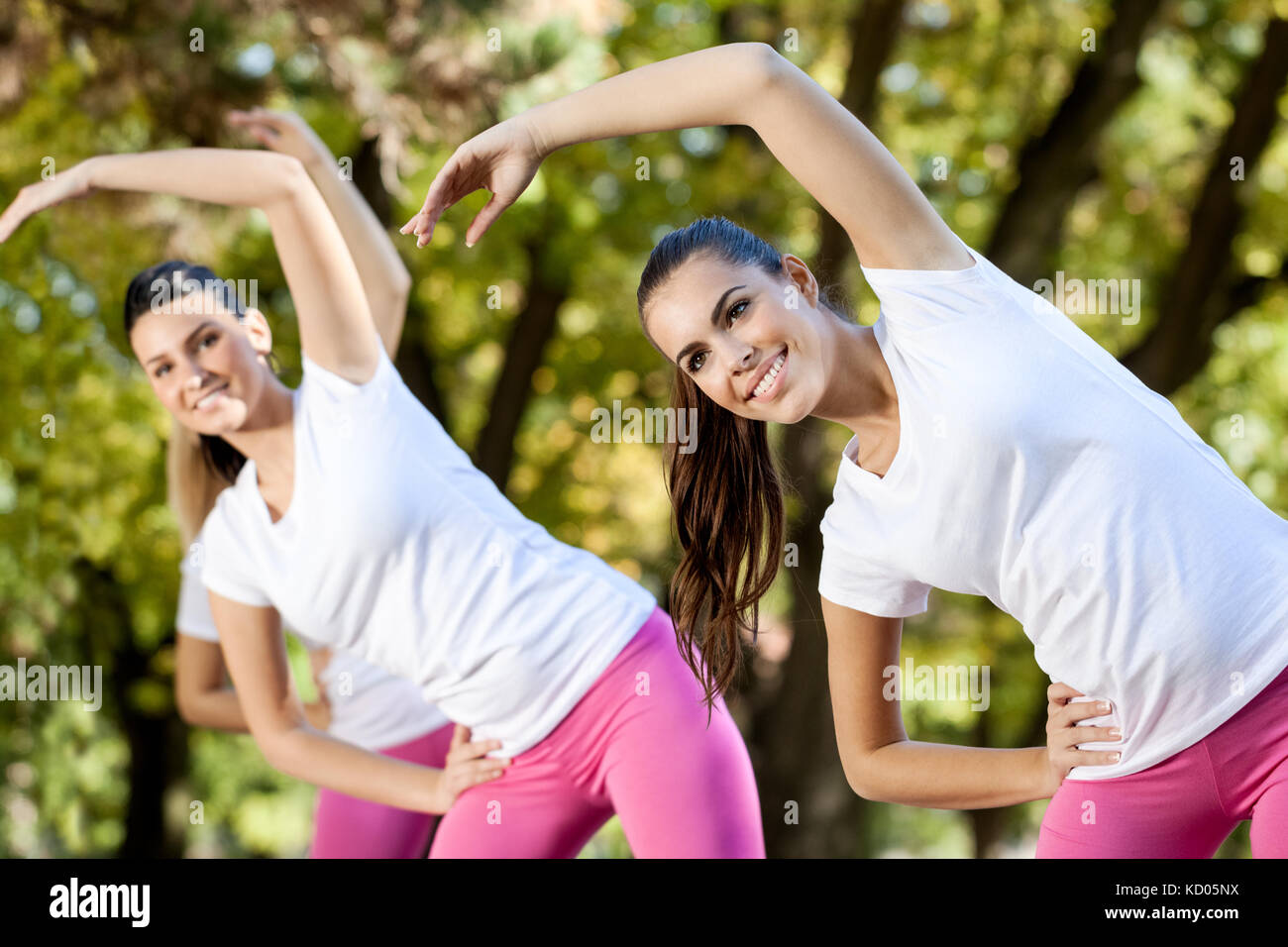 Young women stretching on aerobics class, outdoor Stock Photo - Alamy