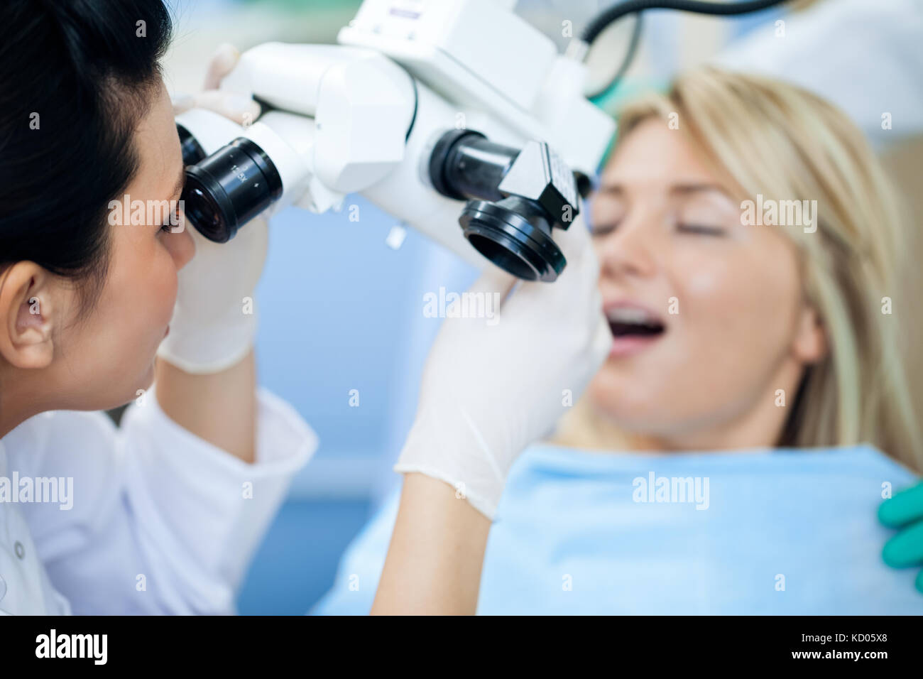 dentist examination patient`s teeth with microscope at surgery office ...