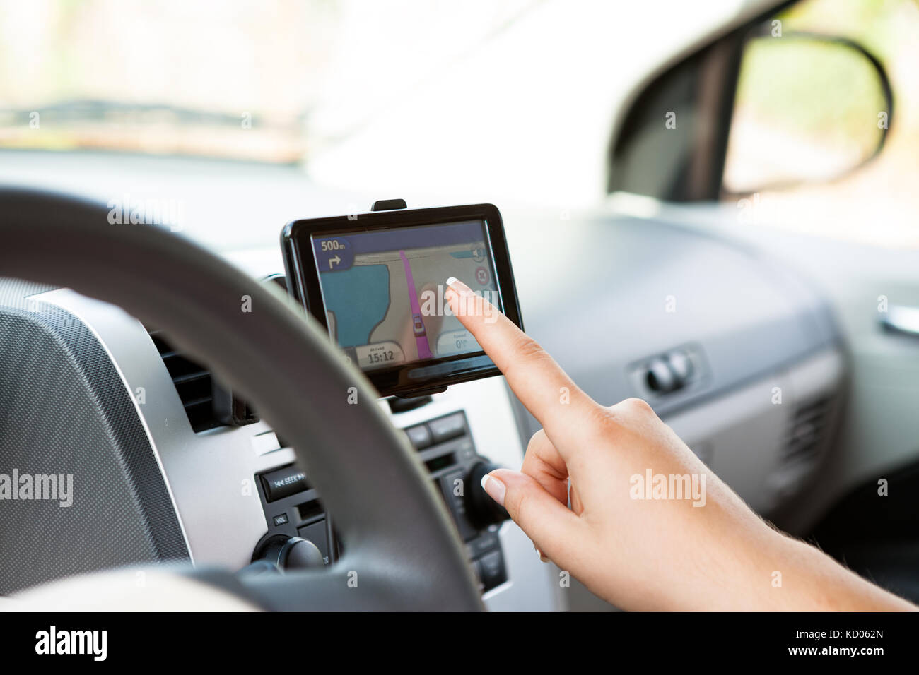 GPS navigation panel on dashboard inside a car. Finger pointing on ...