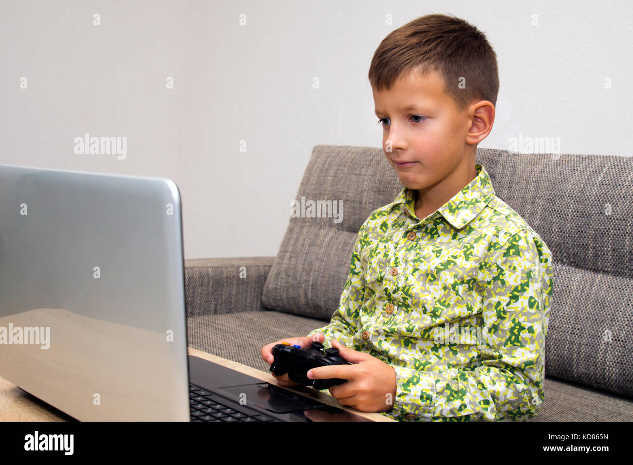 Cute boy playing video games at home Stock Photo - Alamy