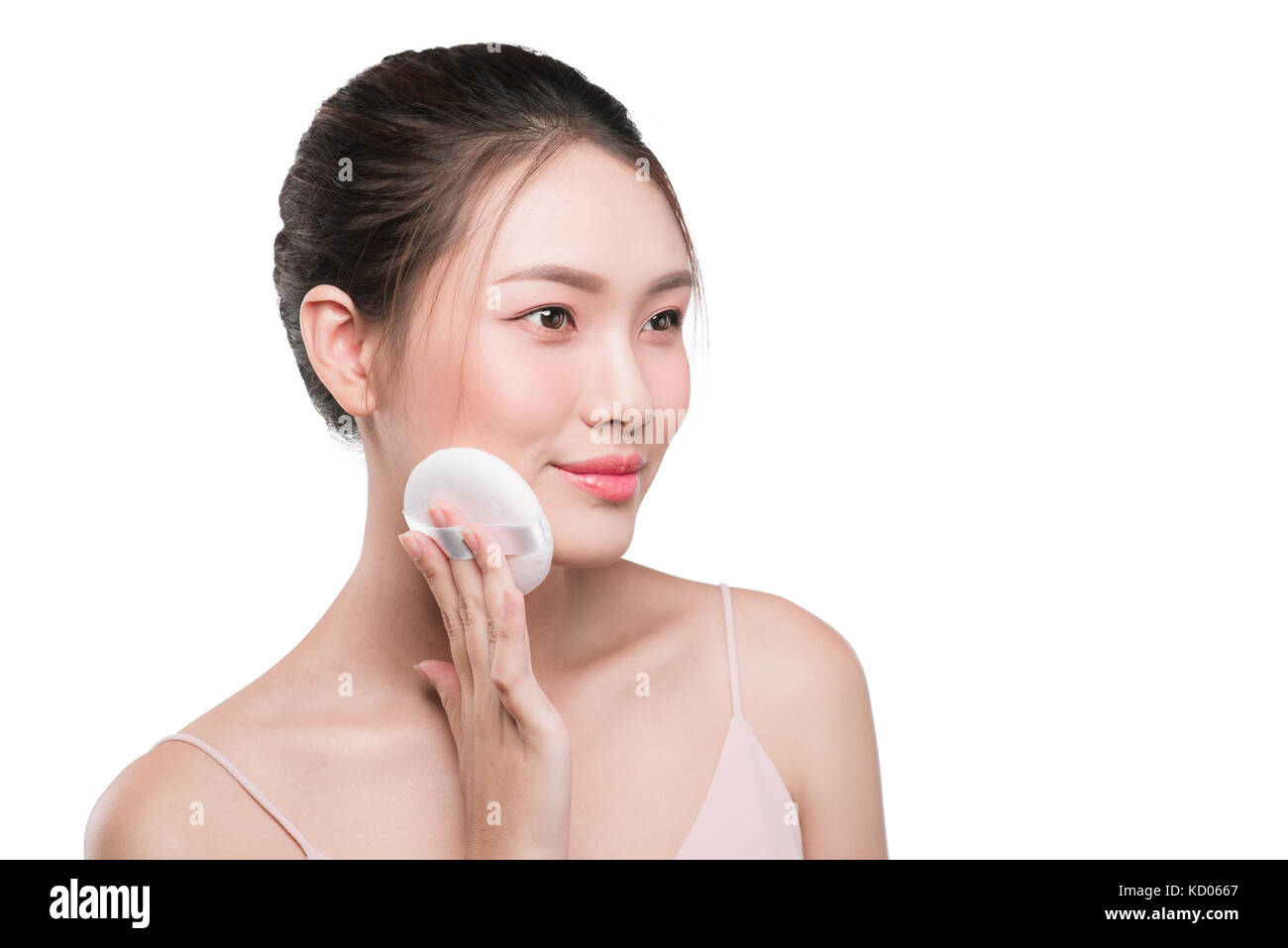 Portrait of beautiful young asian model applying some powder using ...