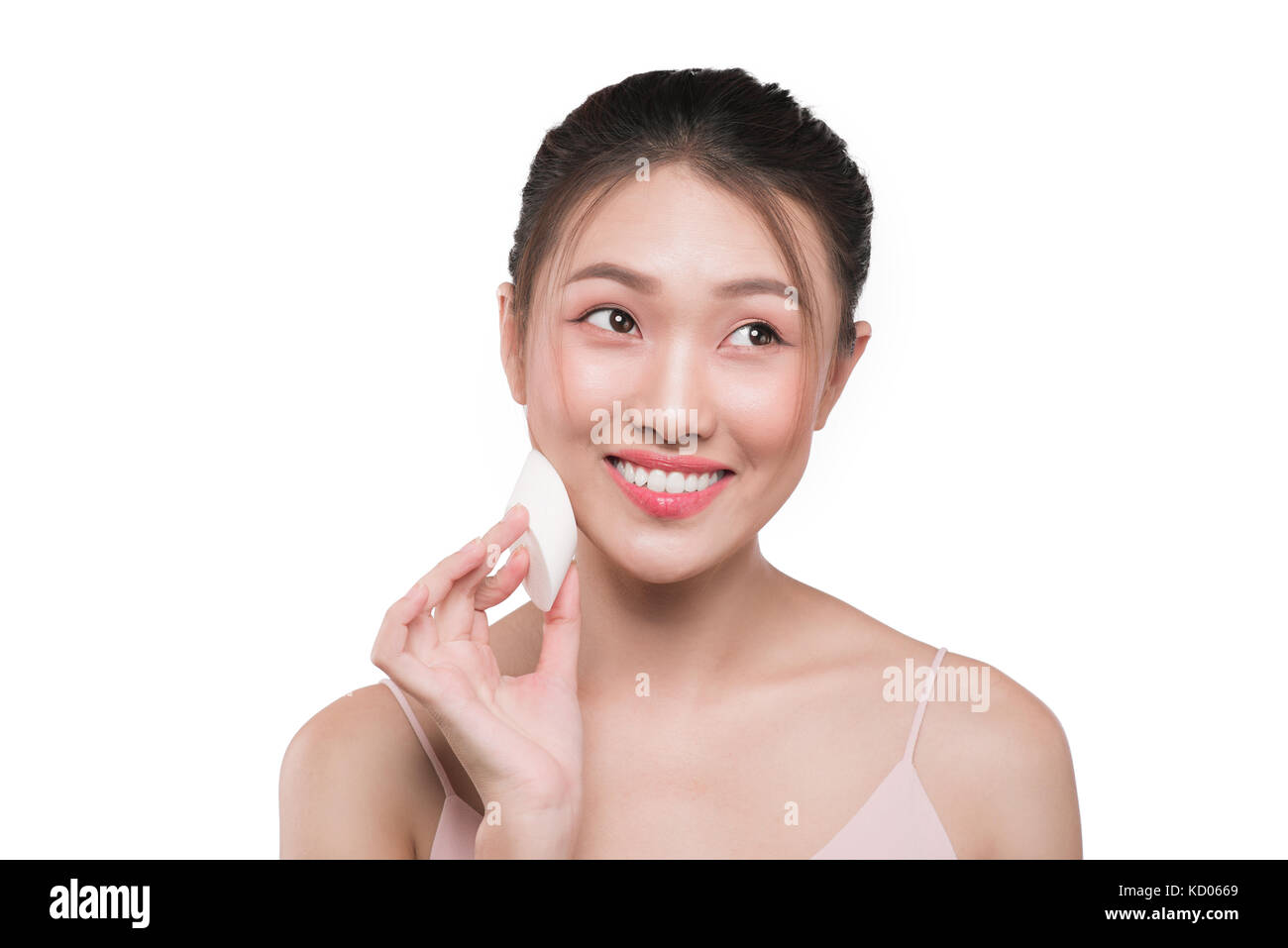 Attractive woman putting on make up, applied liquid foundation on her ...