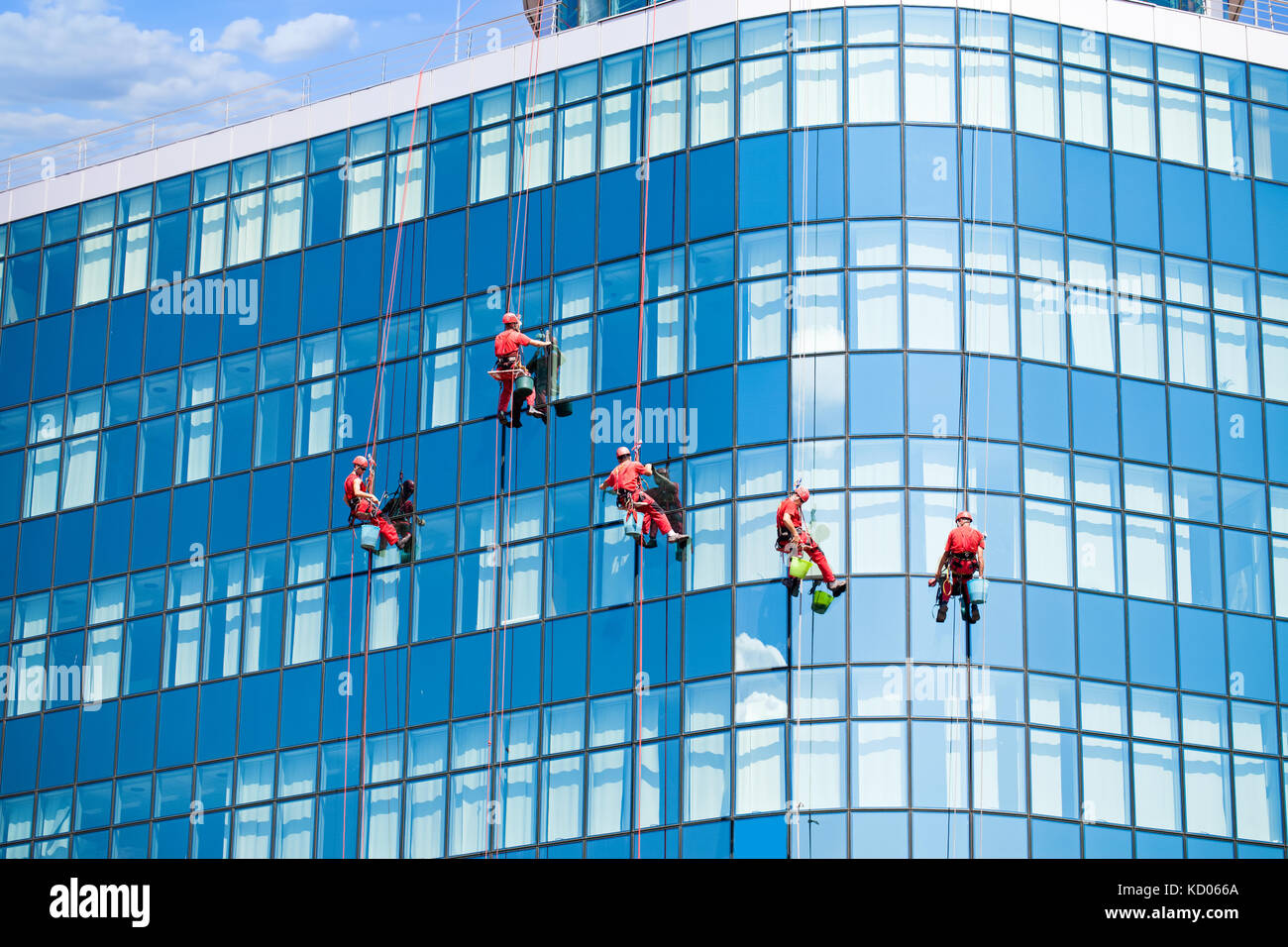 Five window cleaners on modern building Stock Photo - Alamy