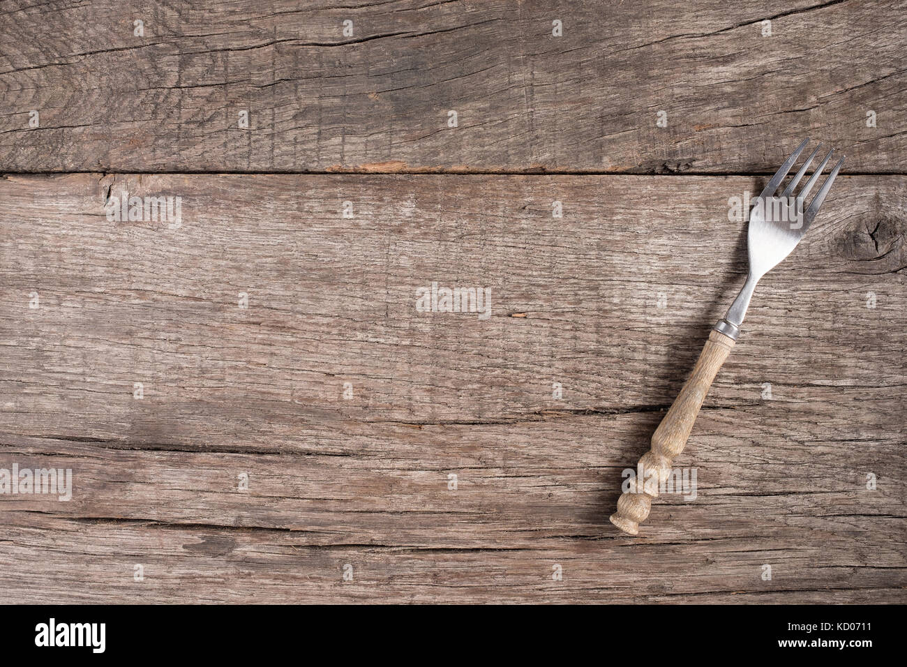 Fork on rustic wooden table with copy space in horizontal format Stock ...