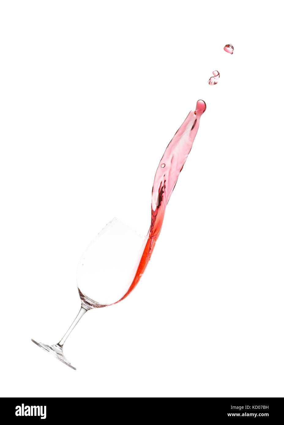 Red wine as splash in wine glass white isolated in vertical format ...