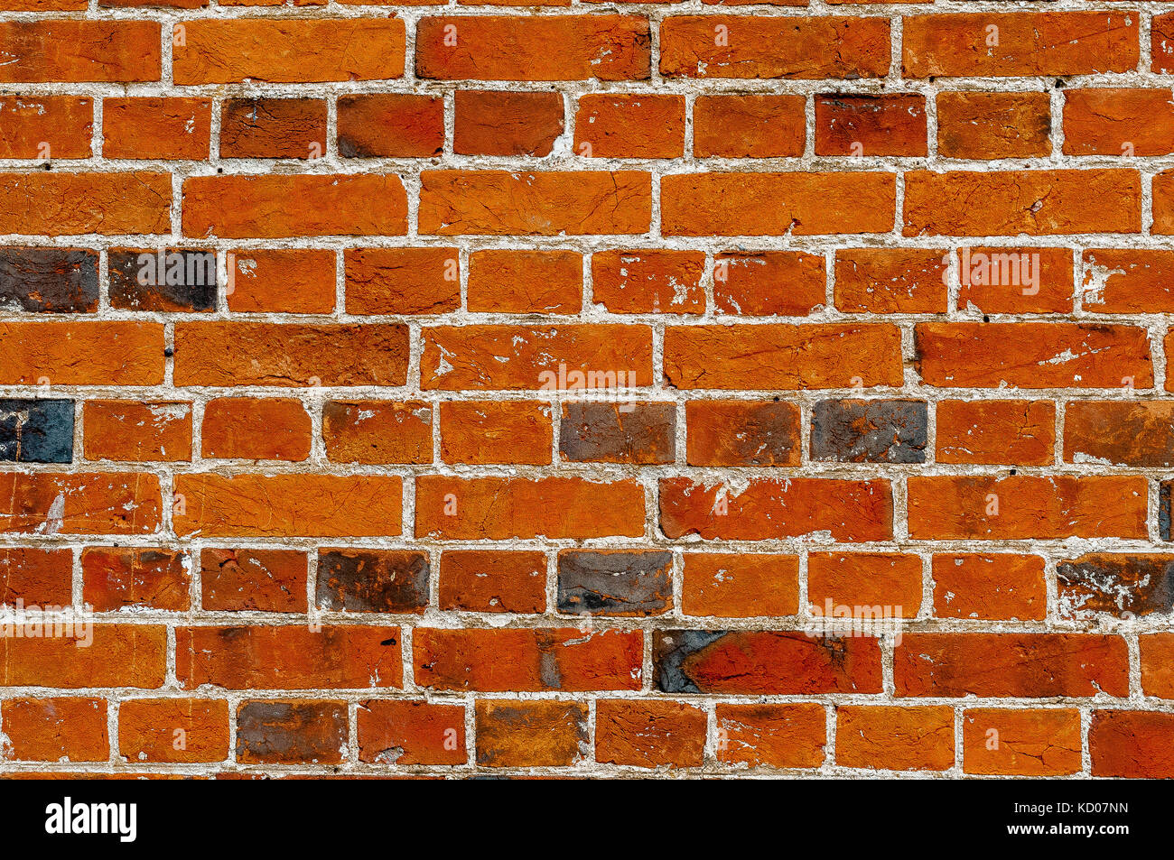 Aged brick wall background texture with a mixture of red, orange and ...