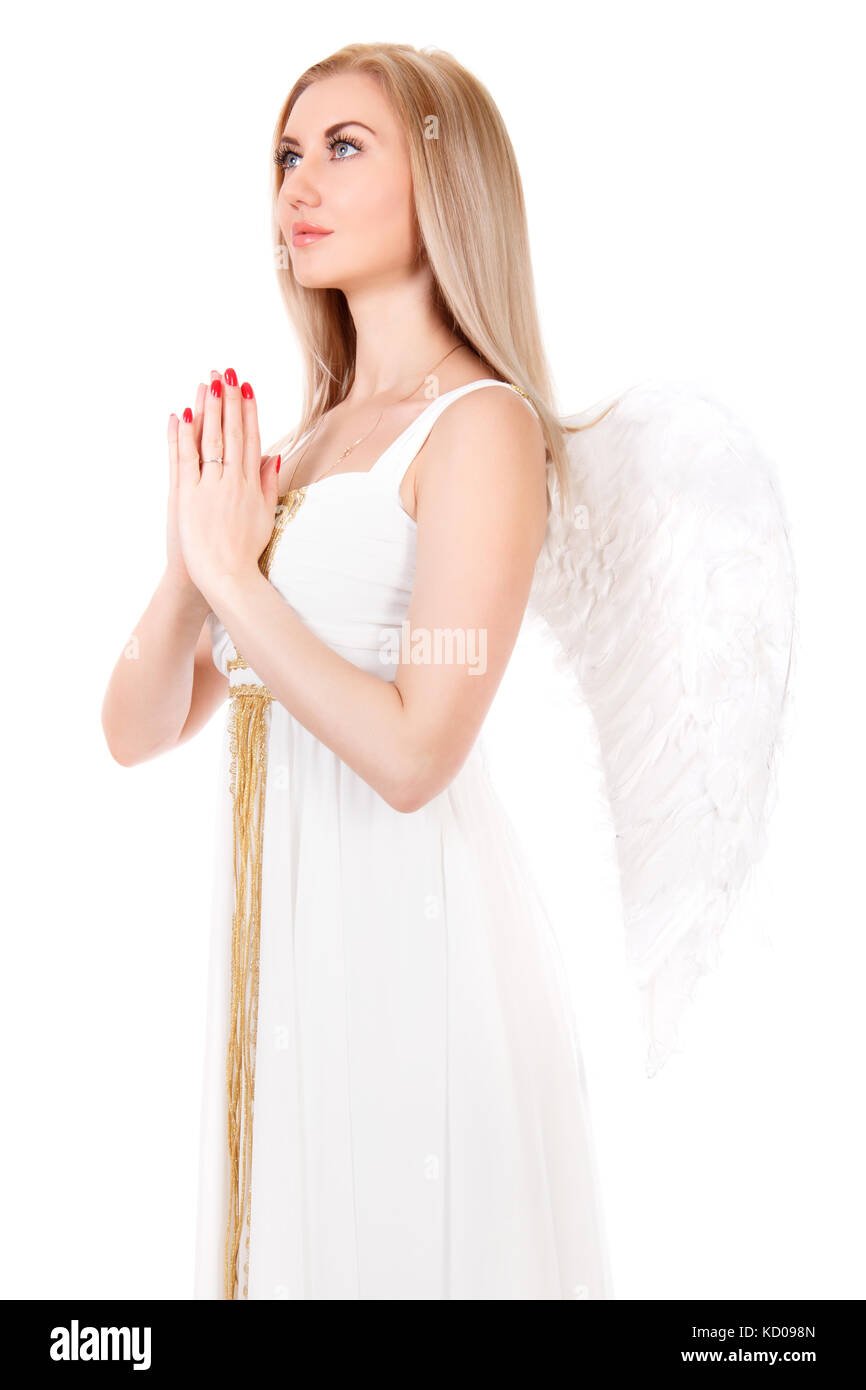 Beautiful praying young woman in a white dress with angel wings ...