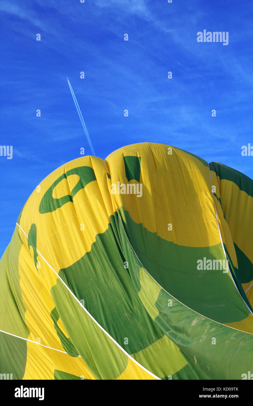 A jet plane flying behind a hot air balloon Stock Photo - Alamy