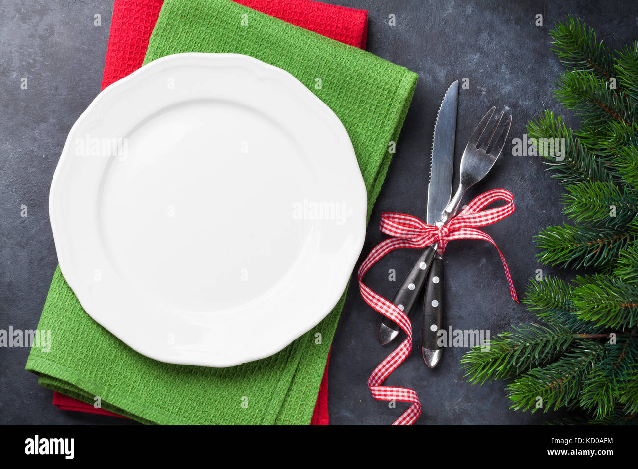 Christmas dinner plate, silverware, fir tree. Top view with copy space ...