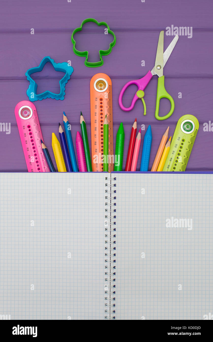 A notebook with colored pencils, rulers and scissors Stock Photo - Alamy