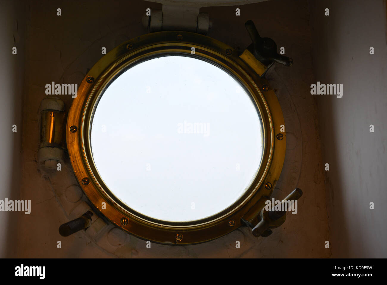Gold porthole from the inside on a ship Stock Photo - Alamy