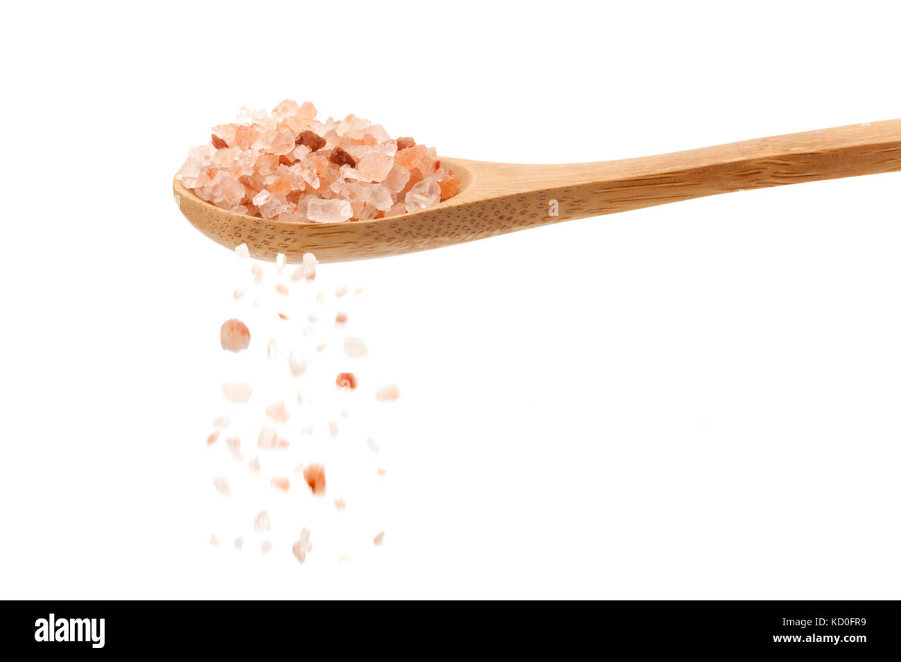 sprinkled some salt in the air from wooden spoon isolated on white ...