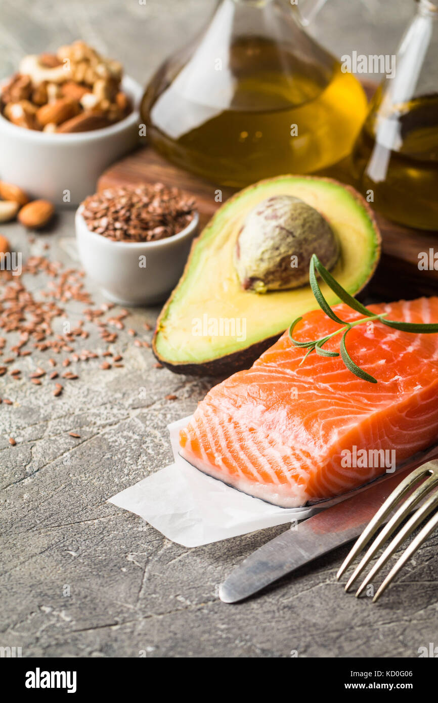 Healthy fats in nutrition - salmon, avocado, oil, nuts. Concept of ...