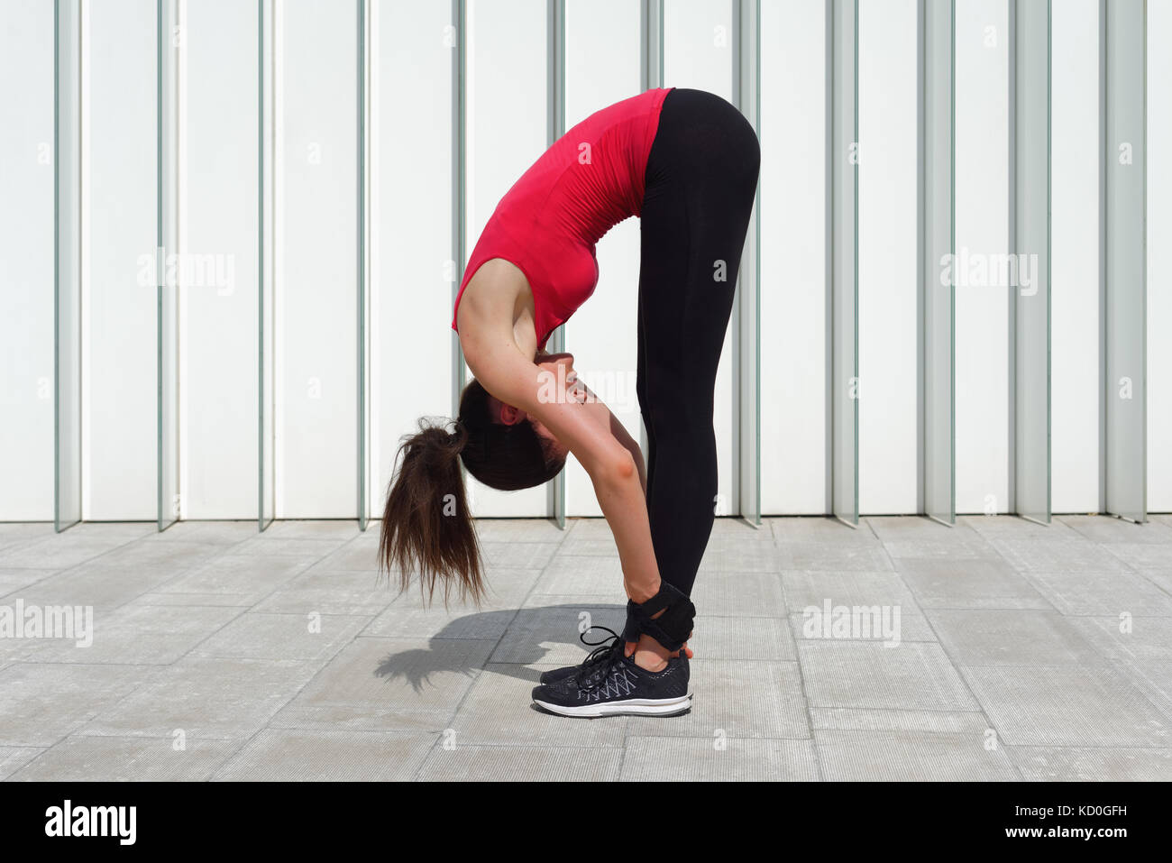 Woman bending over touching toes hi-res stock photography and images ...