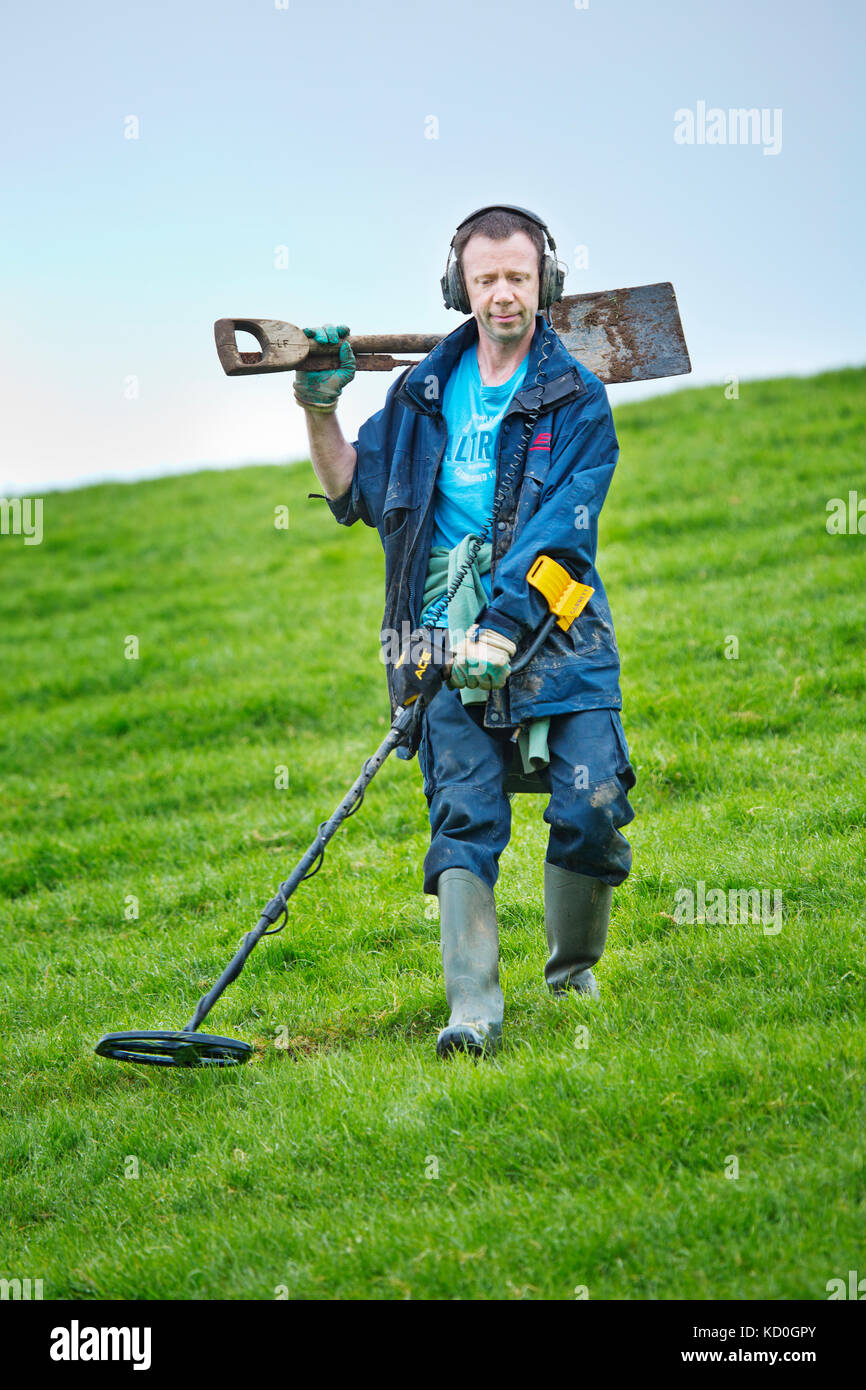 A man metal detecting in a field in Devon Stock Photo - Alamy