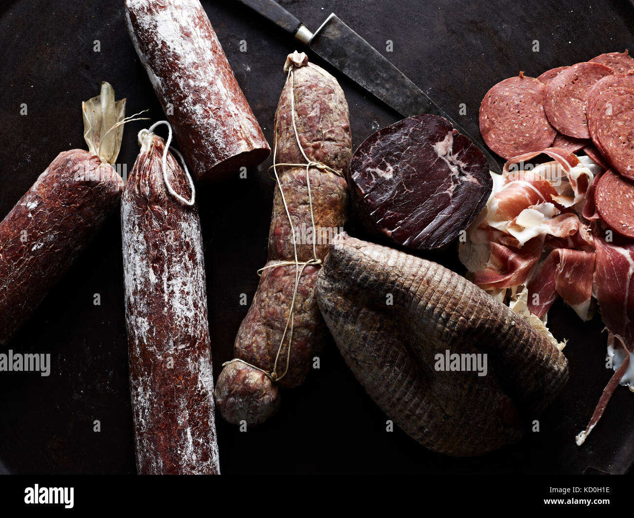 Selection of cured meats, overhead view Stock Photo - Alamy
