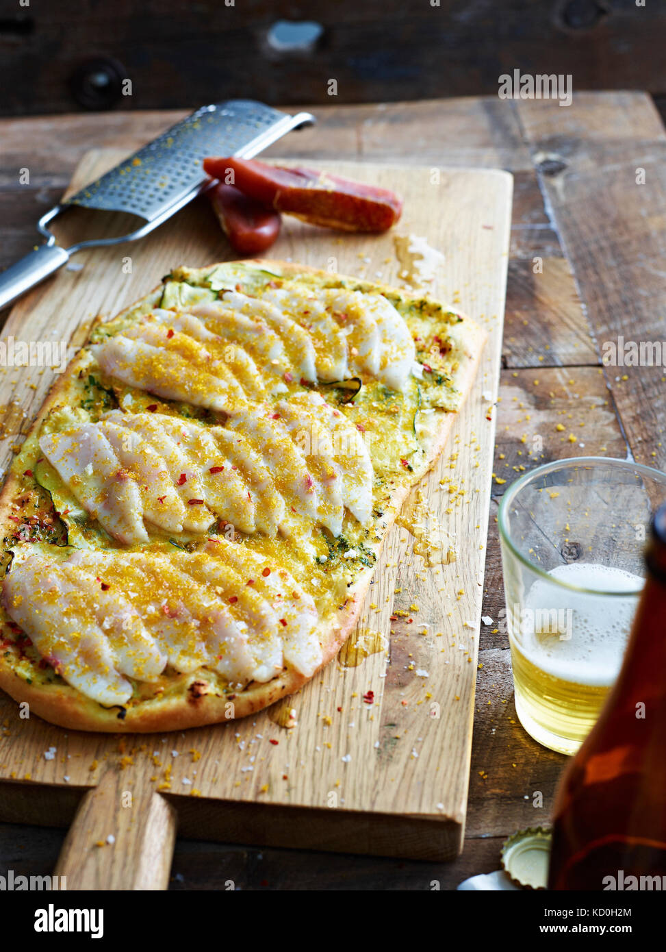 KIng fish carpaccio pizza on serving board Stock Photo - Alamy