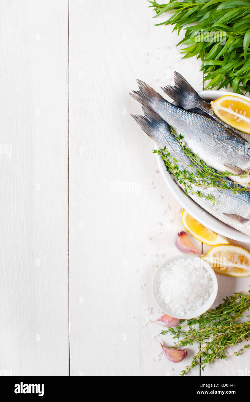 White wooden background with fresh raw fish and ingredients Stock Photo ...