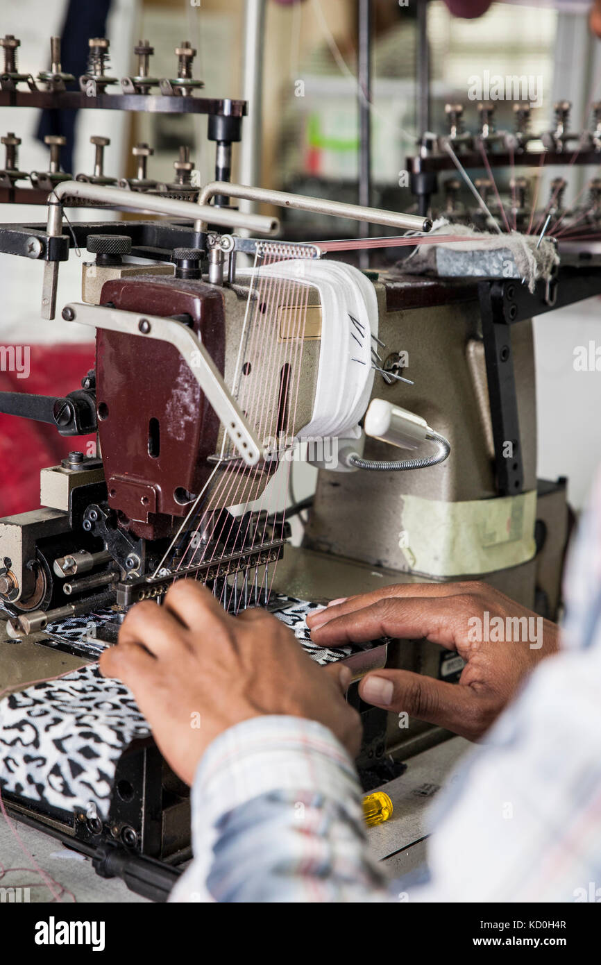 Person working on industrial smocking sewing machine in factory, Cape ...