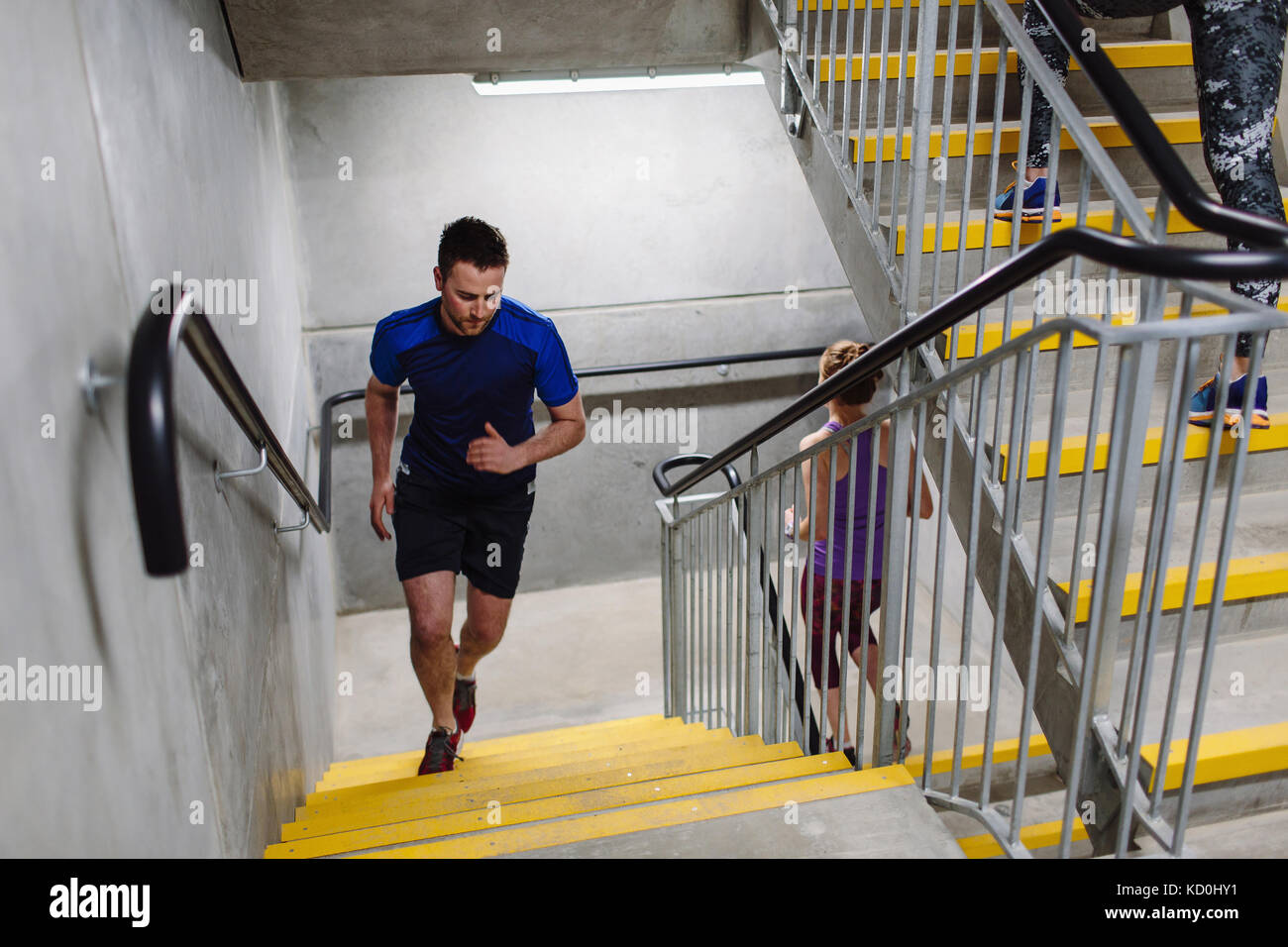 Young male runner running up indoor stairway Stock Photo - Alamy